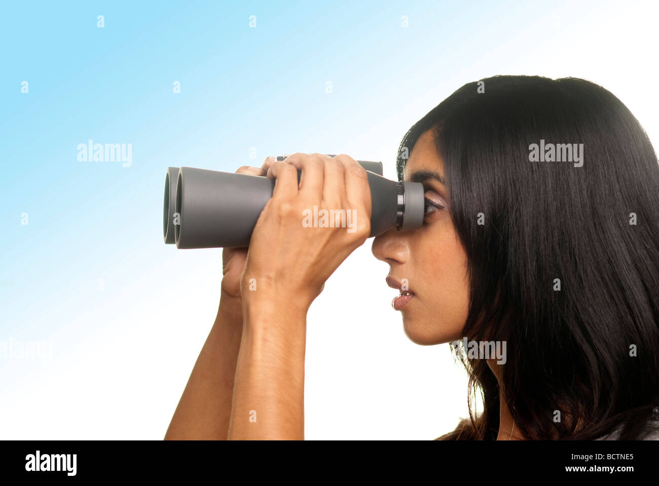 Indian businesswoman looking through binoculars hi-res stock ...