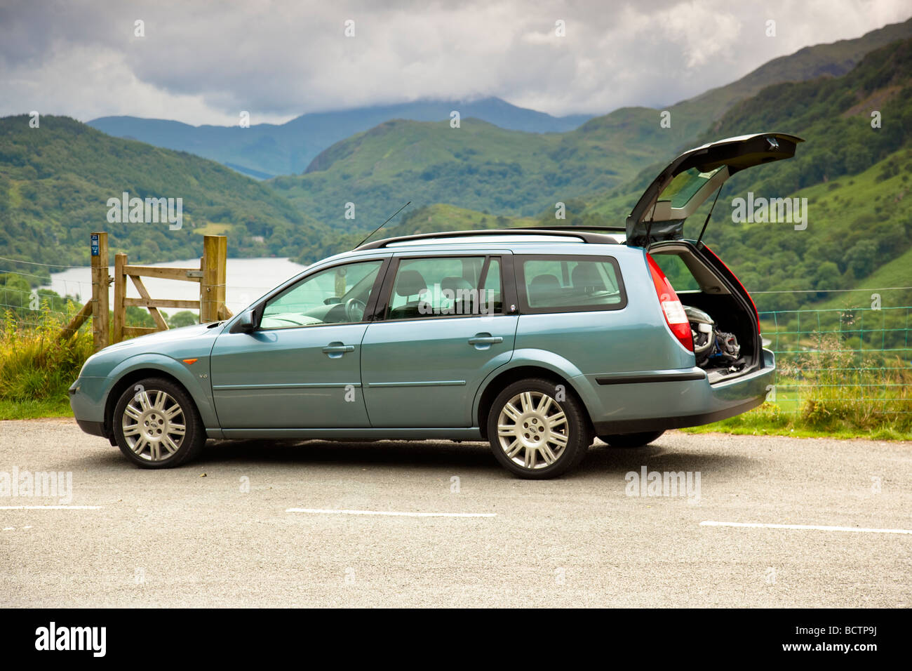 A tourist car with its boot open stopped with its boot open at a ...