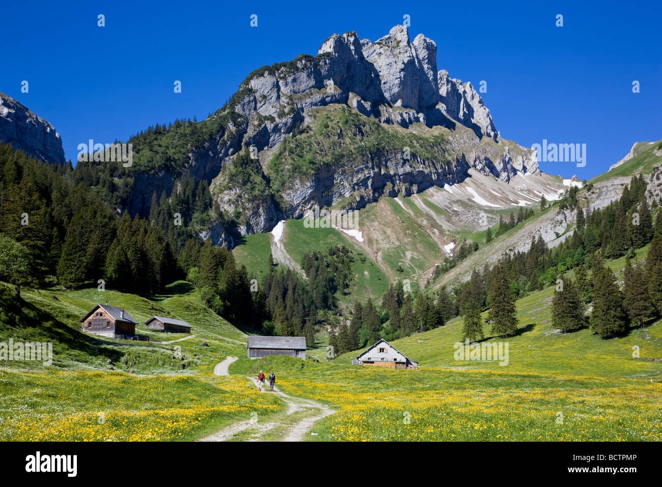 Hikers couple on trail in the Alpstein, Appenzell Switzerland Stock ...