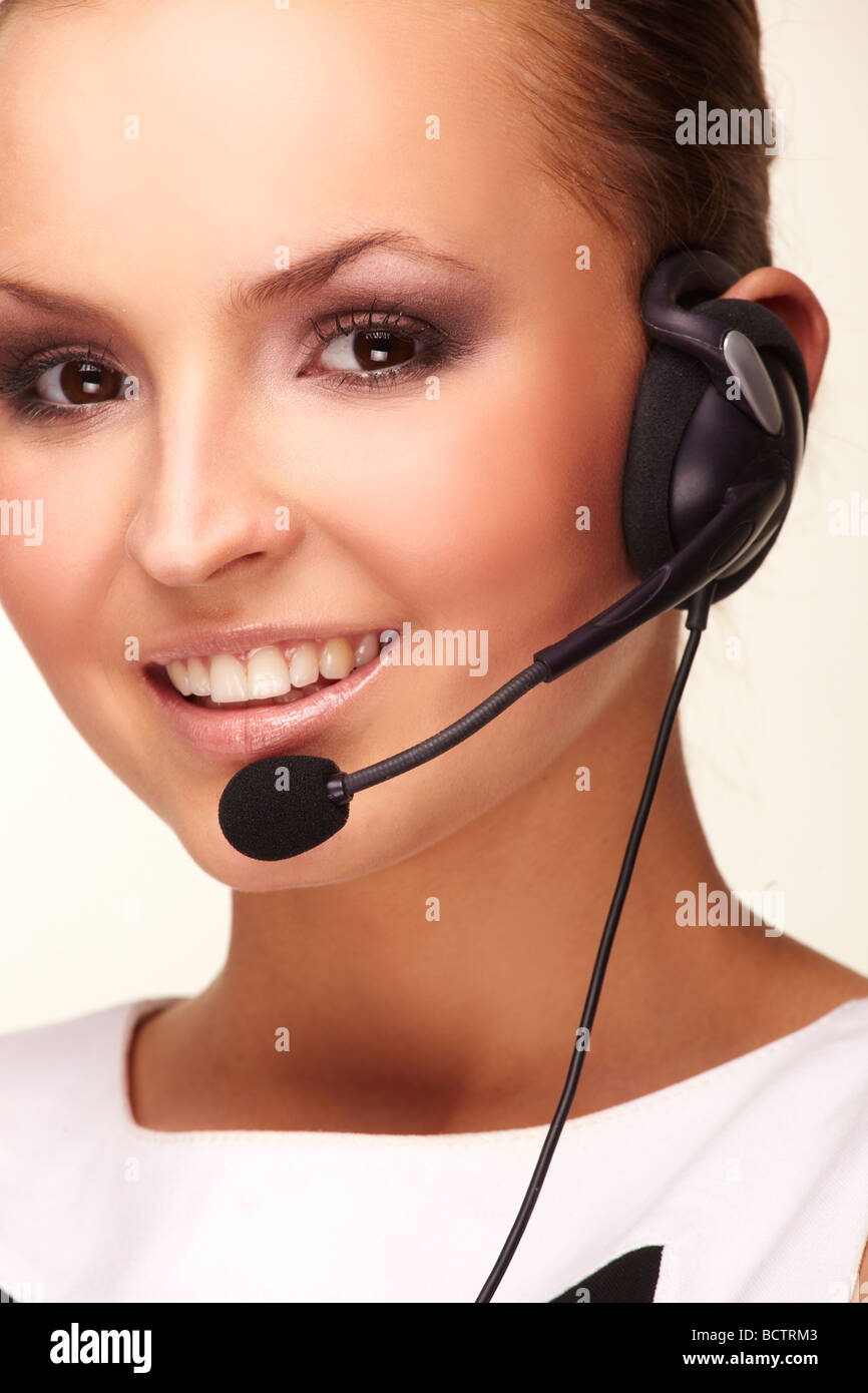 A nice and smiling hotline operator with headset Stock Photo - Alamy