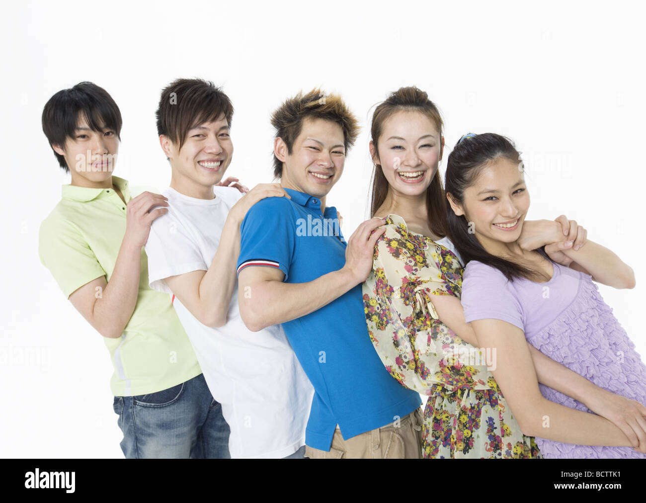Young men and women standing in a row Stock Photo - Alamy