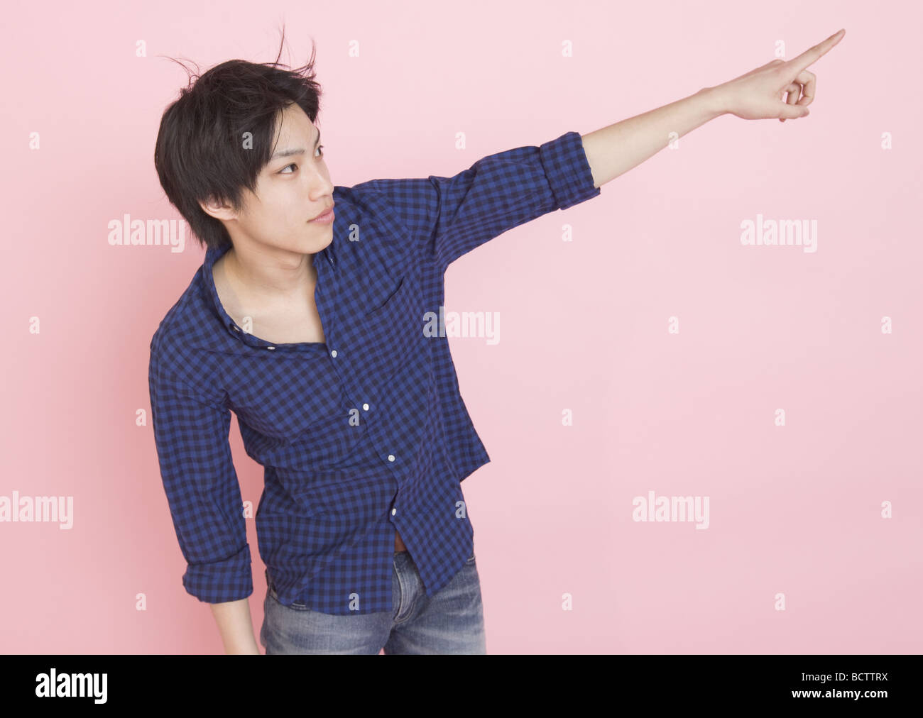 Young man pointing Stock Photo - Alamy