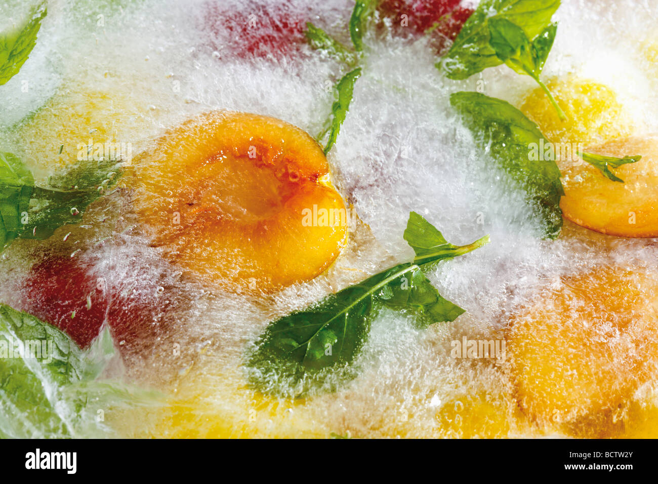 Peaches in a block of ice Stock Photo - Alamy
