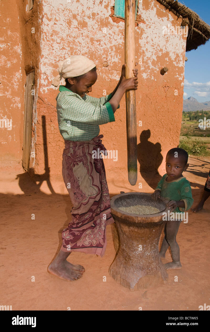 pounding grain in a mortar in rural Madagascar Stock Photo - Alamy