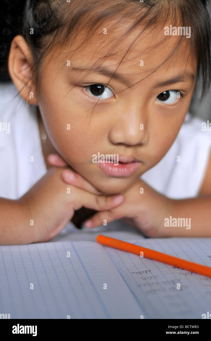 Young Asian child doing homework for school Stock Photo - Alamy