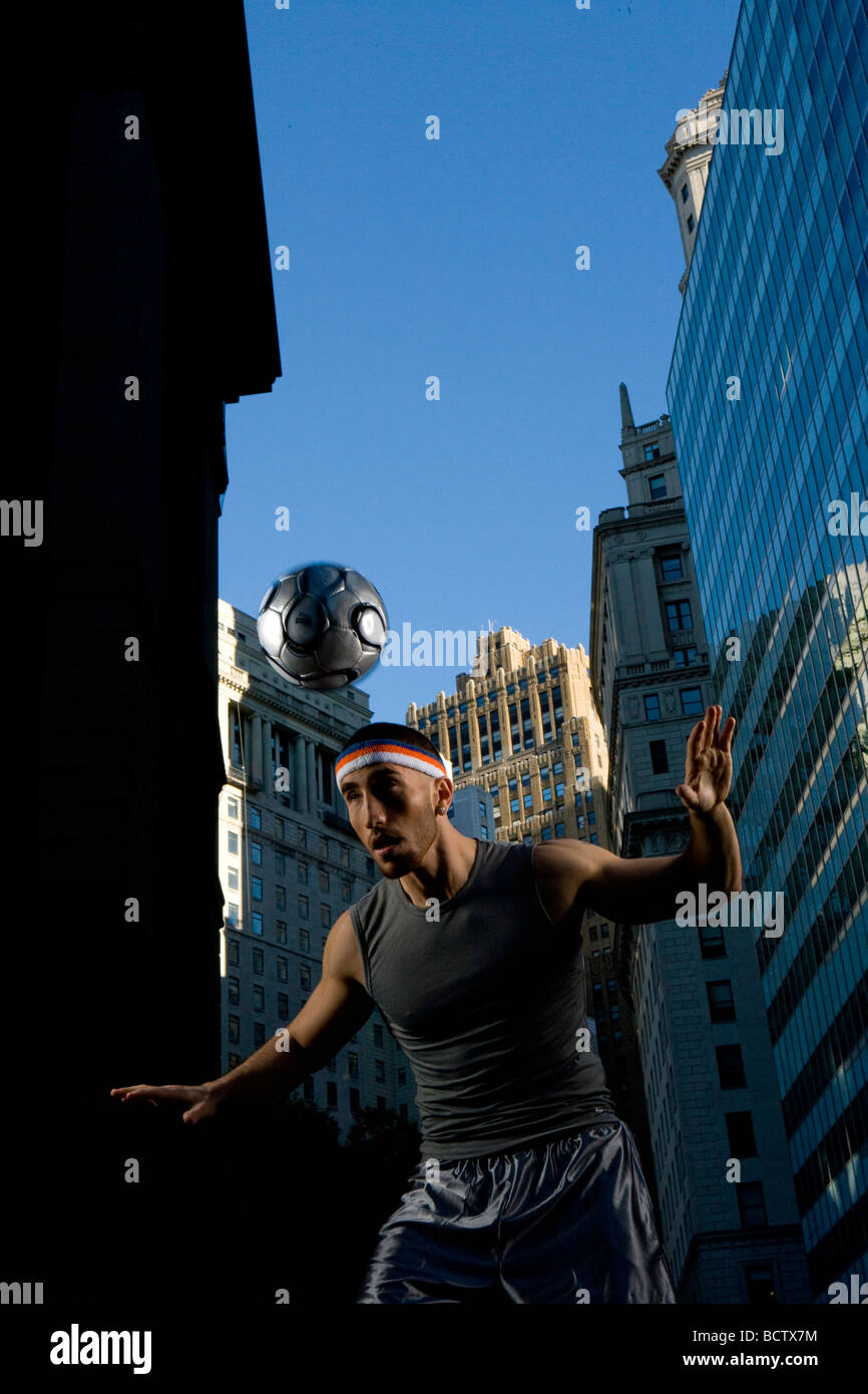 Young man heading a soccer ball Stock Photo - Alamy