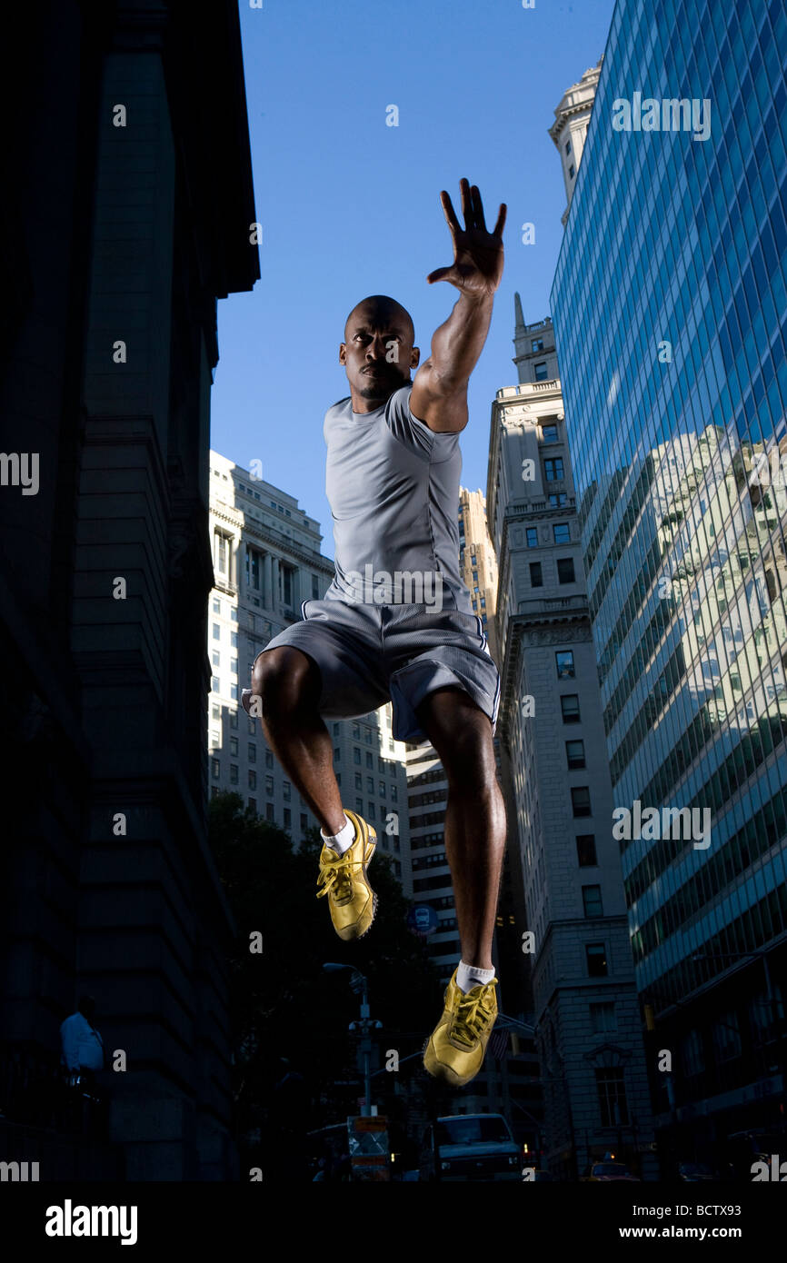Low angle view of a mid adult man jumping Stock Photo - Alamy