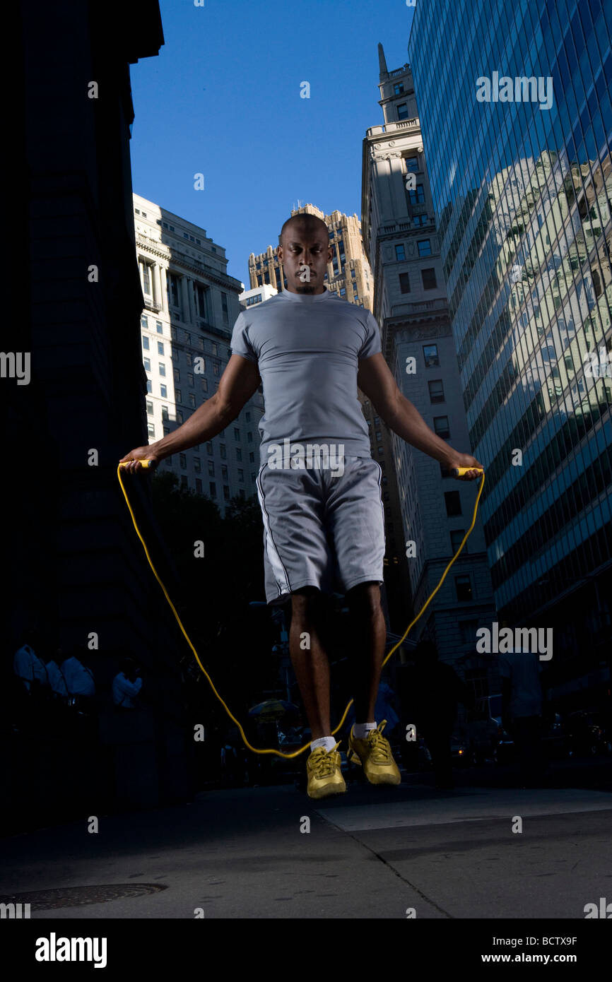 Mid adult man jumping rope Stock Photo - Alamy