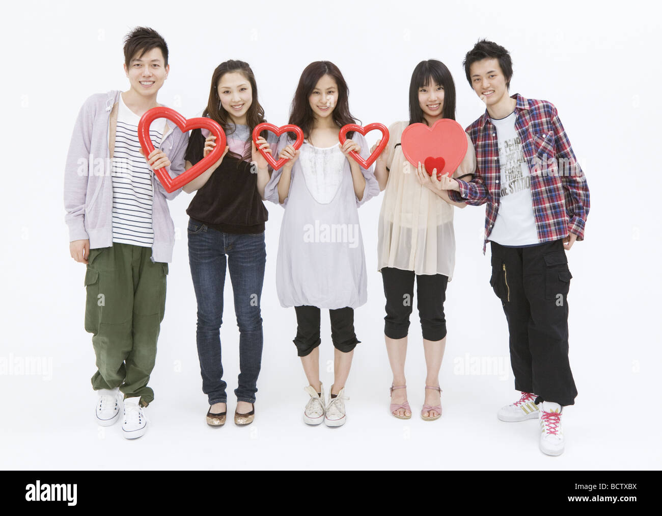 Young men women hold Cut Out Stock Images & Pictures - Alamy