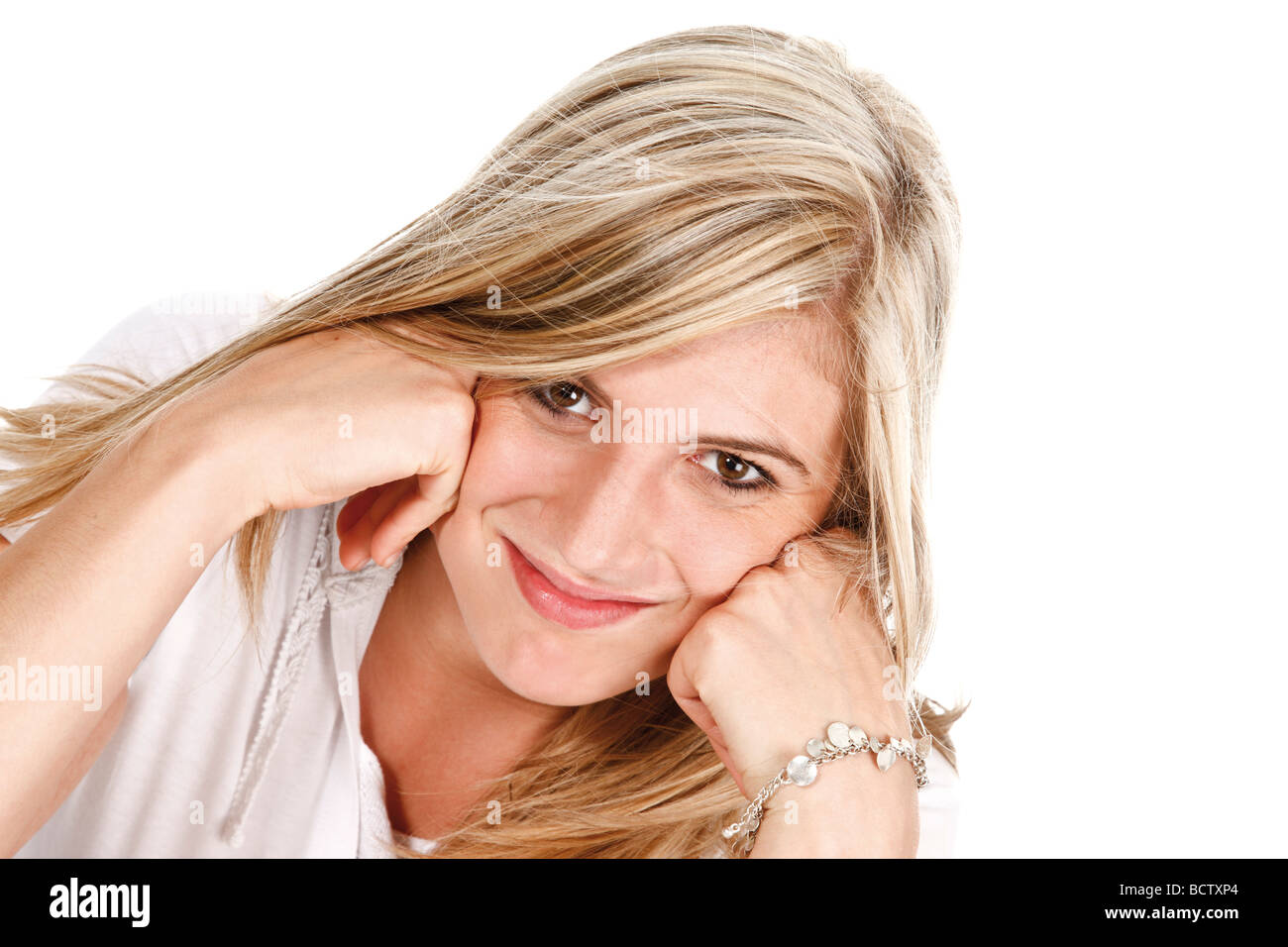 Young woman smiling, head leaning on her hands Stock Photo - Alamy