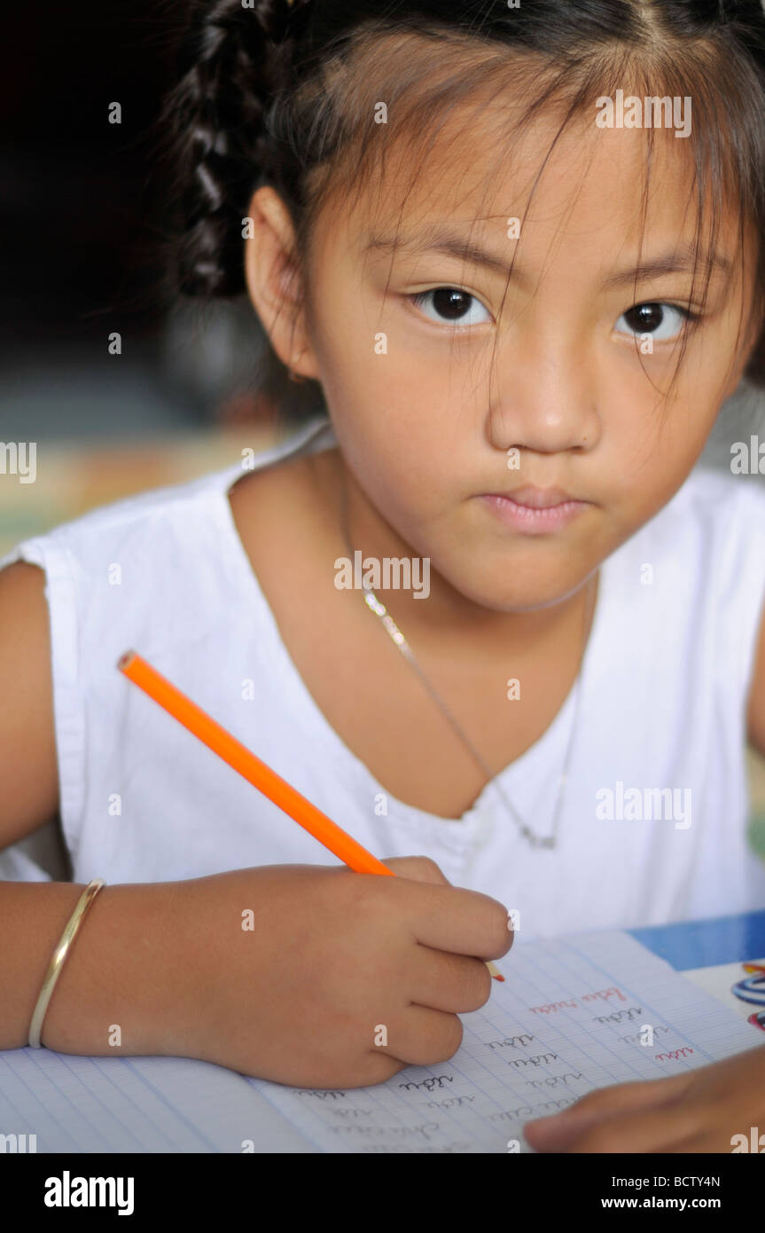 Young Asian child doing homework for school Stock Photo - Alamy