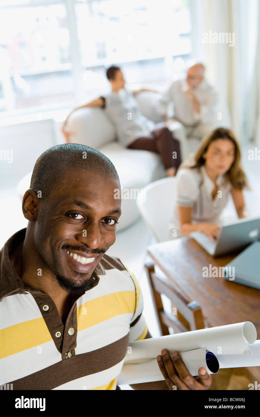 High angle view of a mid adult man holding blueprints and smiling Stock ...