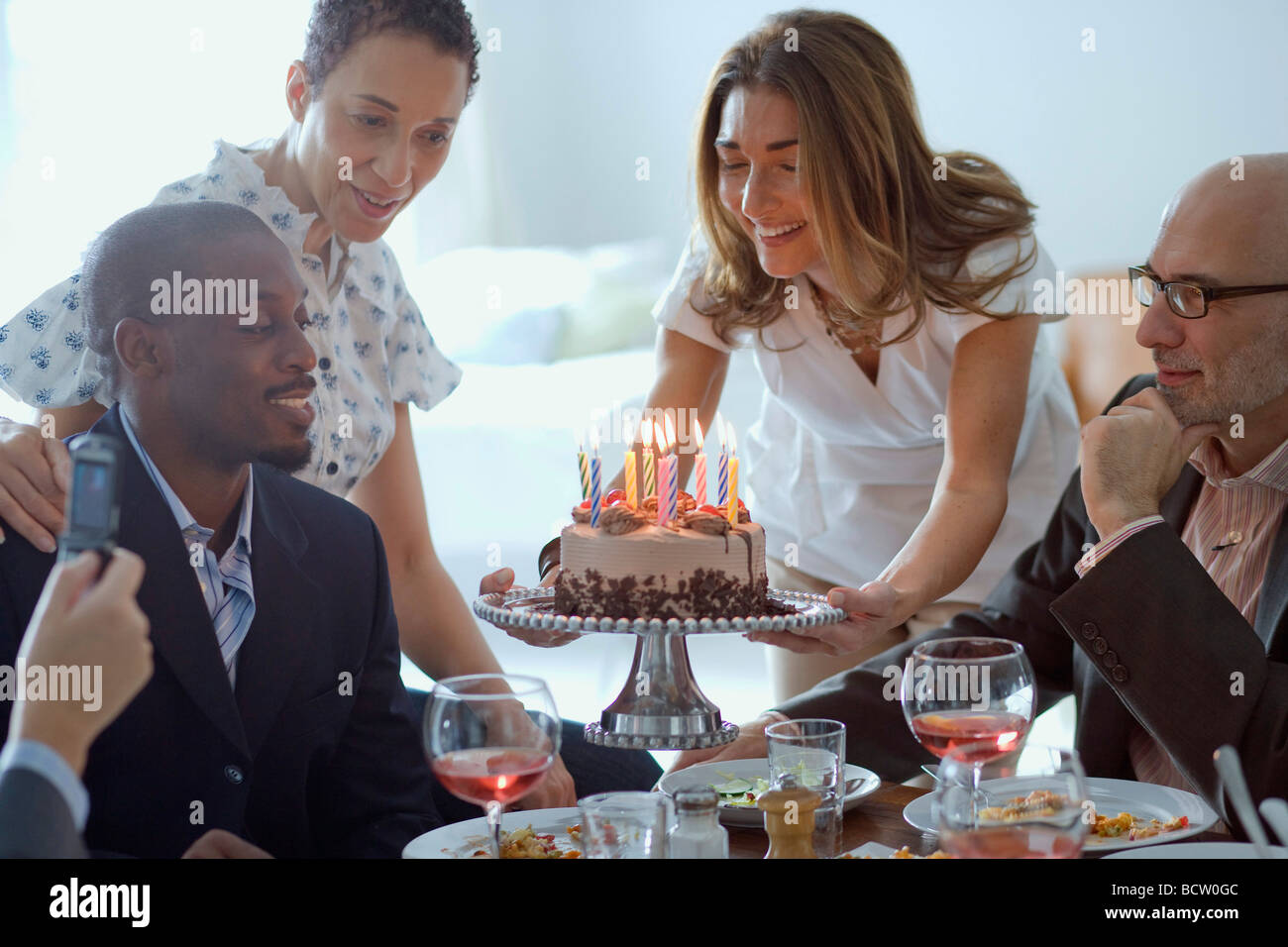 Adults sitting around dinner table hi-res stock photography and images ...