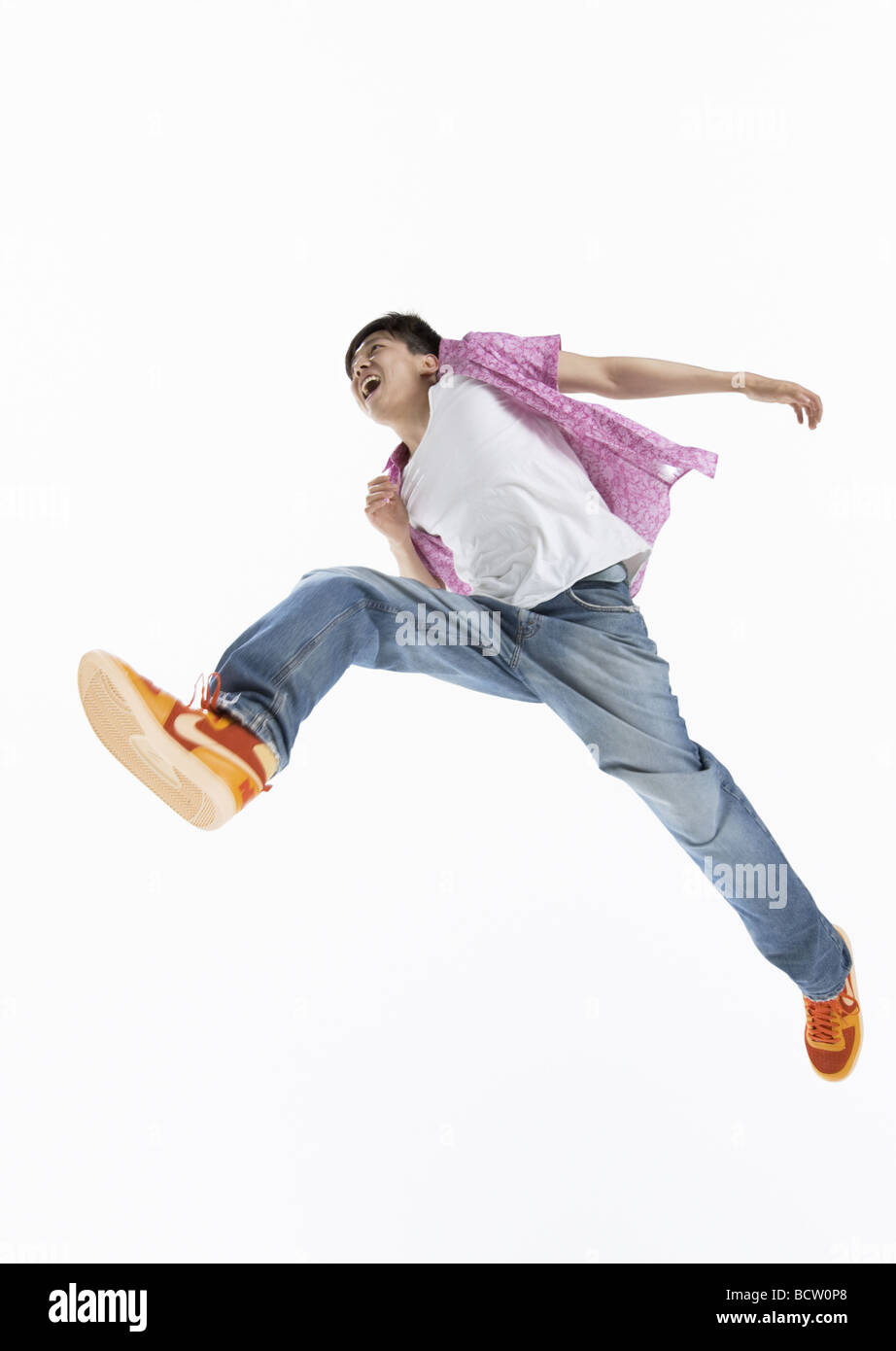 Young man jumping Stock Photo - Alamy