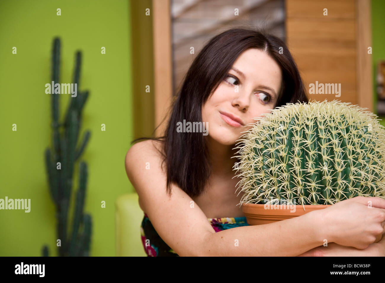 Young woman with a cactus Stock Photo - Alamy