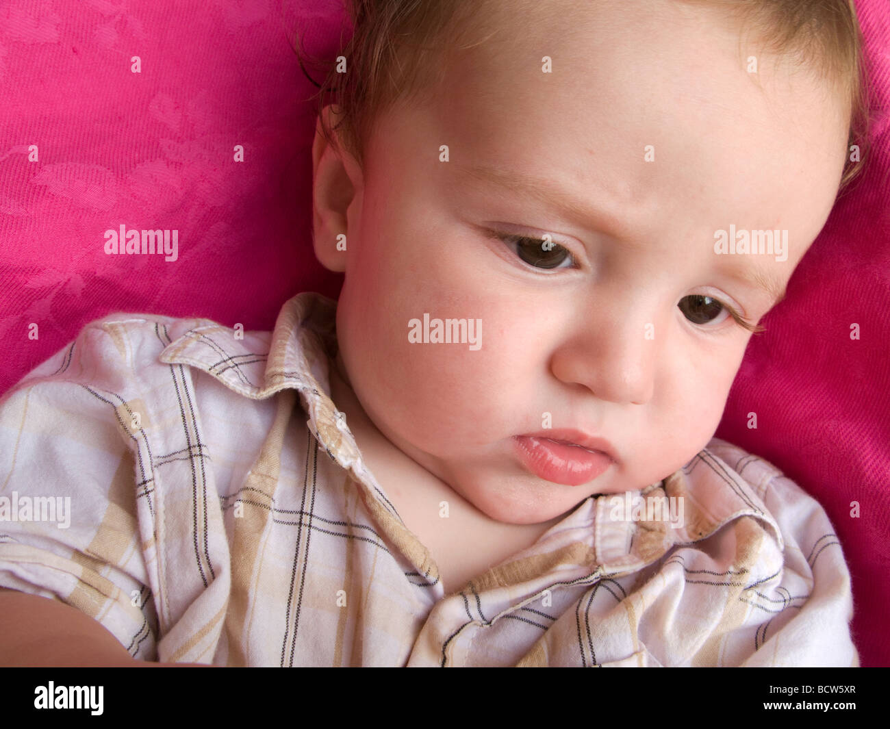 Thoughtful looking six and a half month old baby boy Stock Photo - Alamy