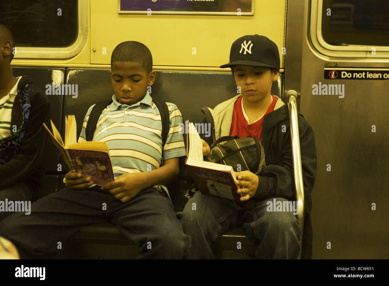 Young boys reading on a New York City subway train in Brooklyn New York ...
