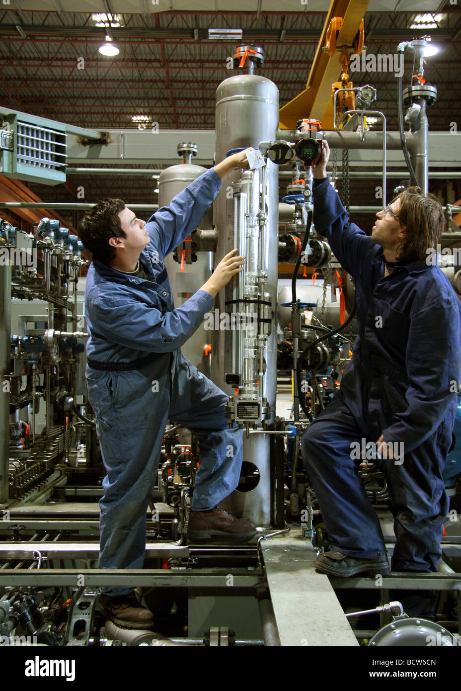 Two engineers working on a gas compressor Stock Photo - Alamy