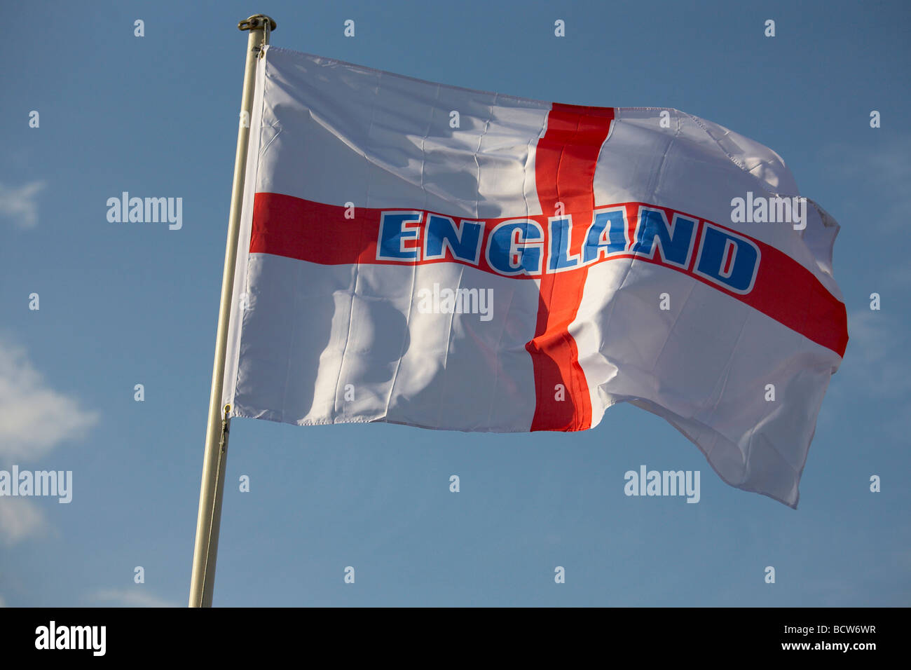 England flag flying against blue sky Stock Photo - Alamy