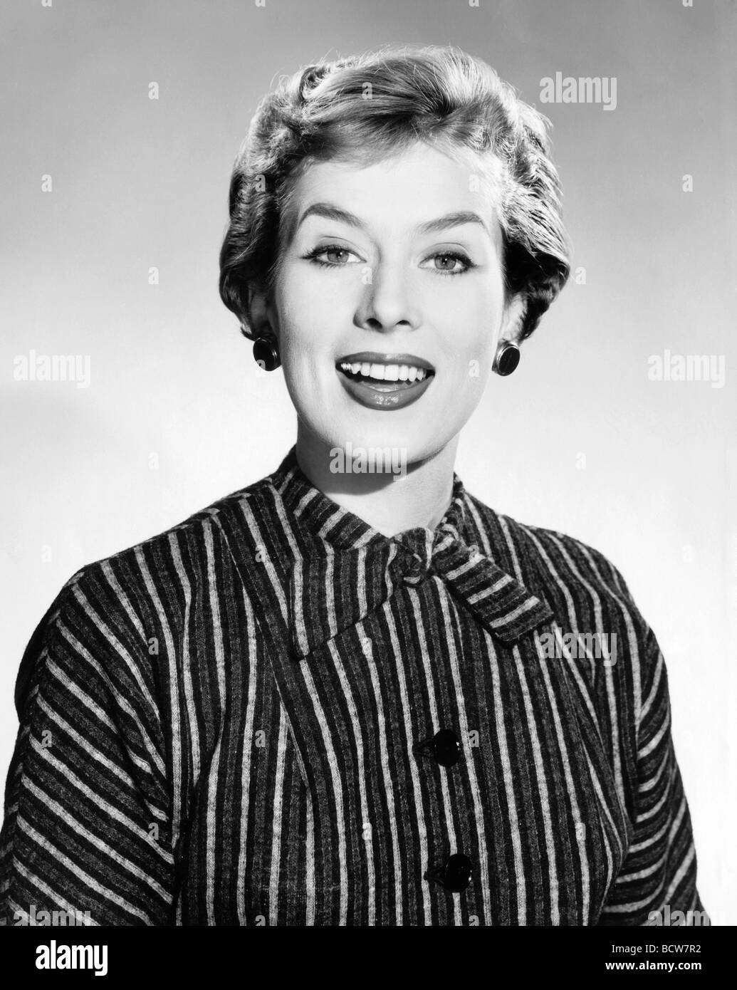 Studio portrait of mid adult woman smiling Stock Photo - Alamy