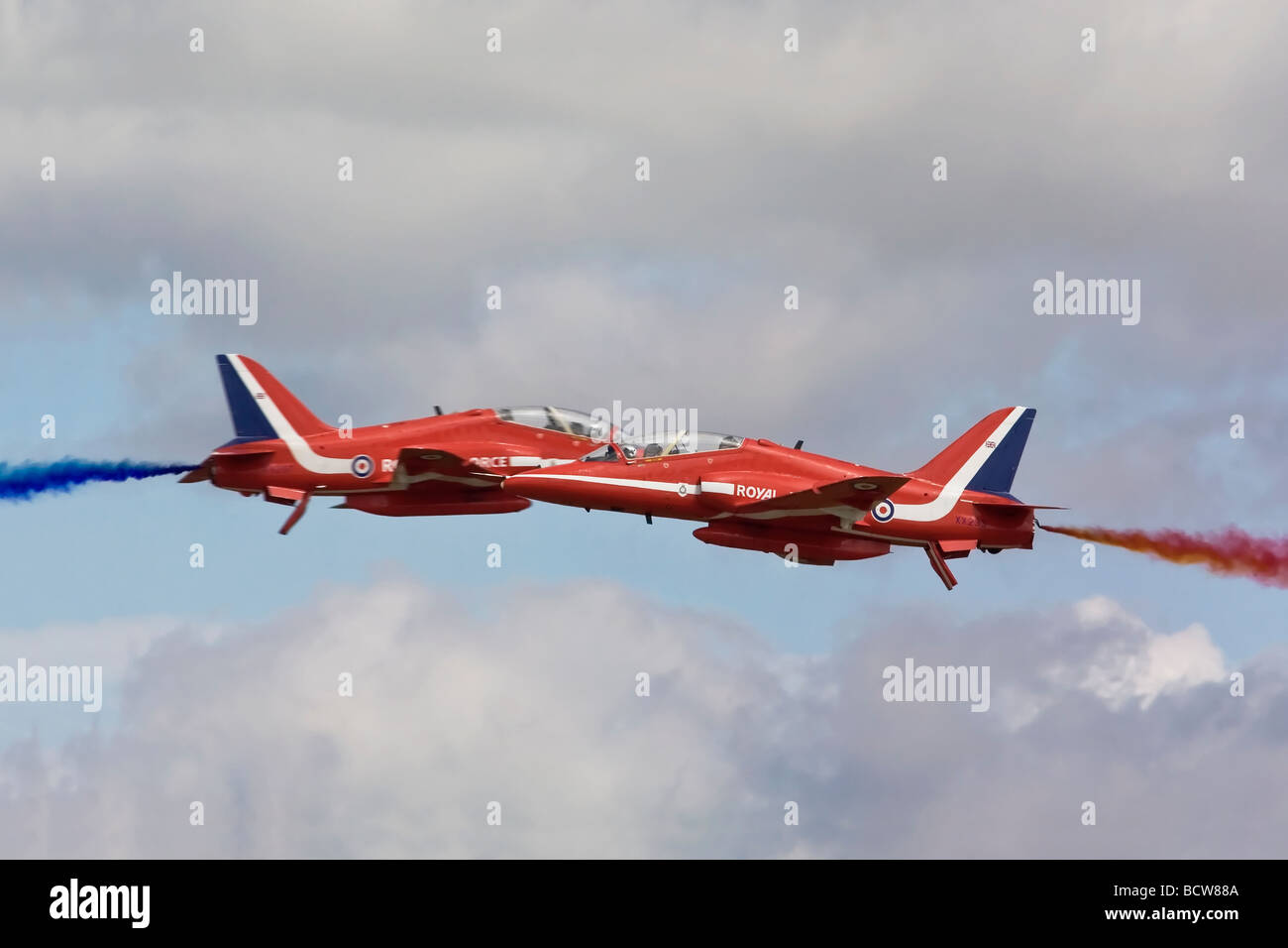 The RAF Red Arrows synchro pair high speed cross over Stock Photo - Alamy