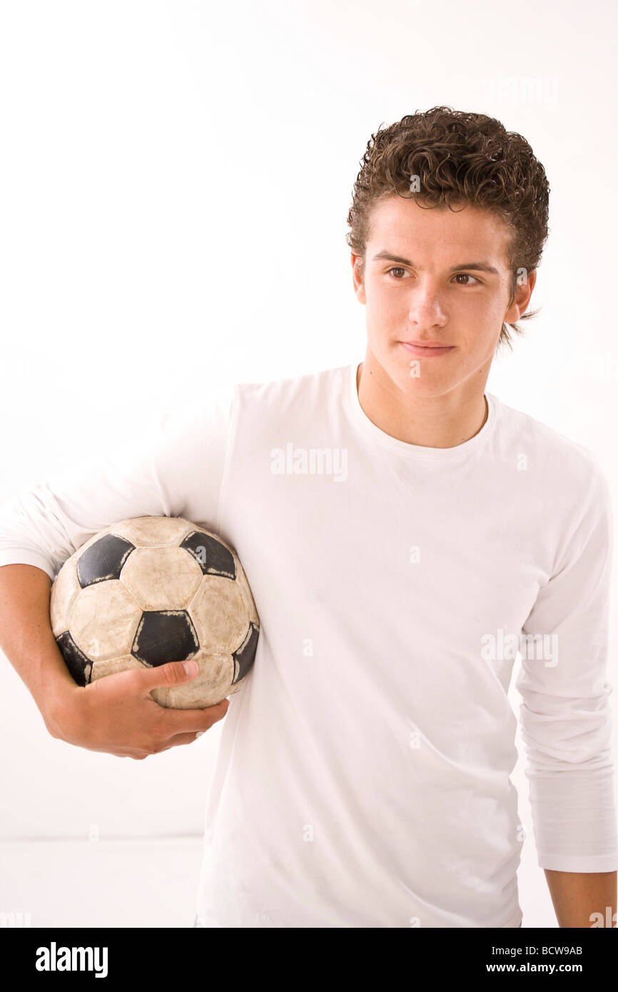 Boy holding a football under his arm Stock Photo - Alamy