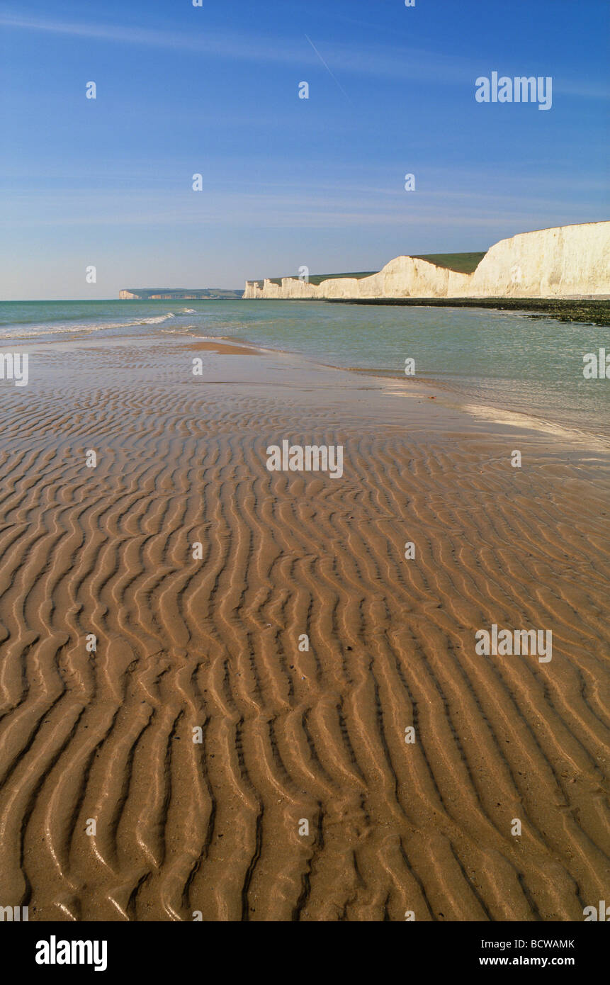 Rippled pattern on sand with limestone cliff in the background, Seven ...