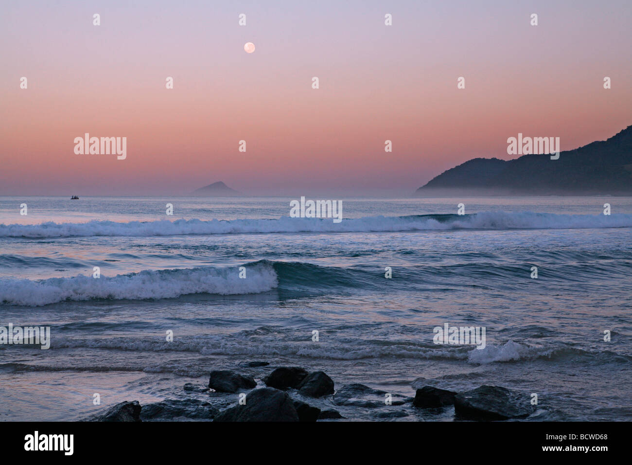 Waves in the sea with moon glowing in the sky, Maresias Beach, Sao ...