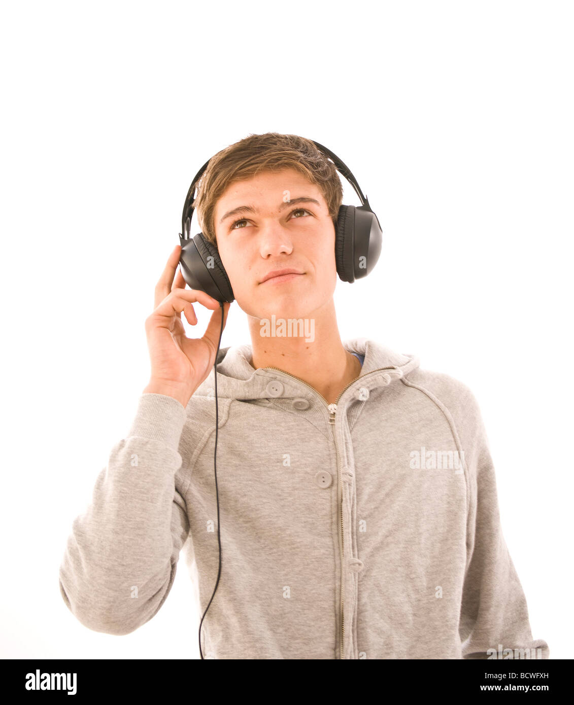 Boy listening to music on headphones Stock Photo - Alamy