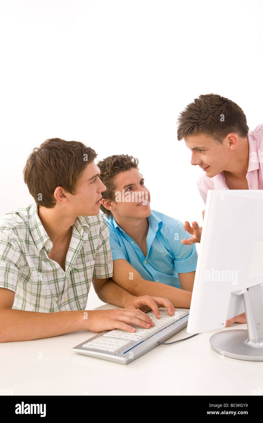 Three boys working together on a computer Stock Photo - Alamy