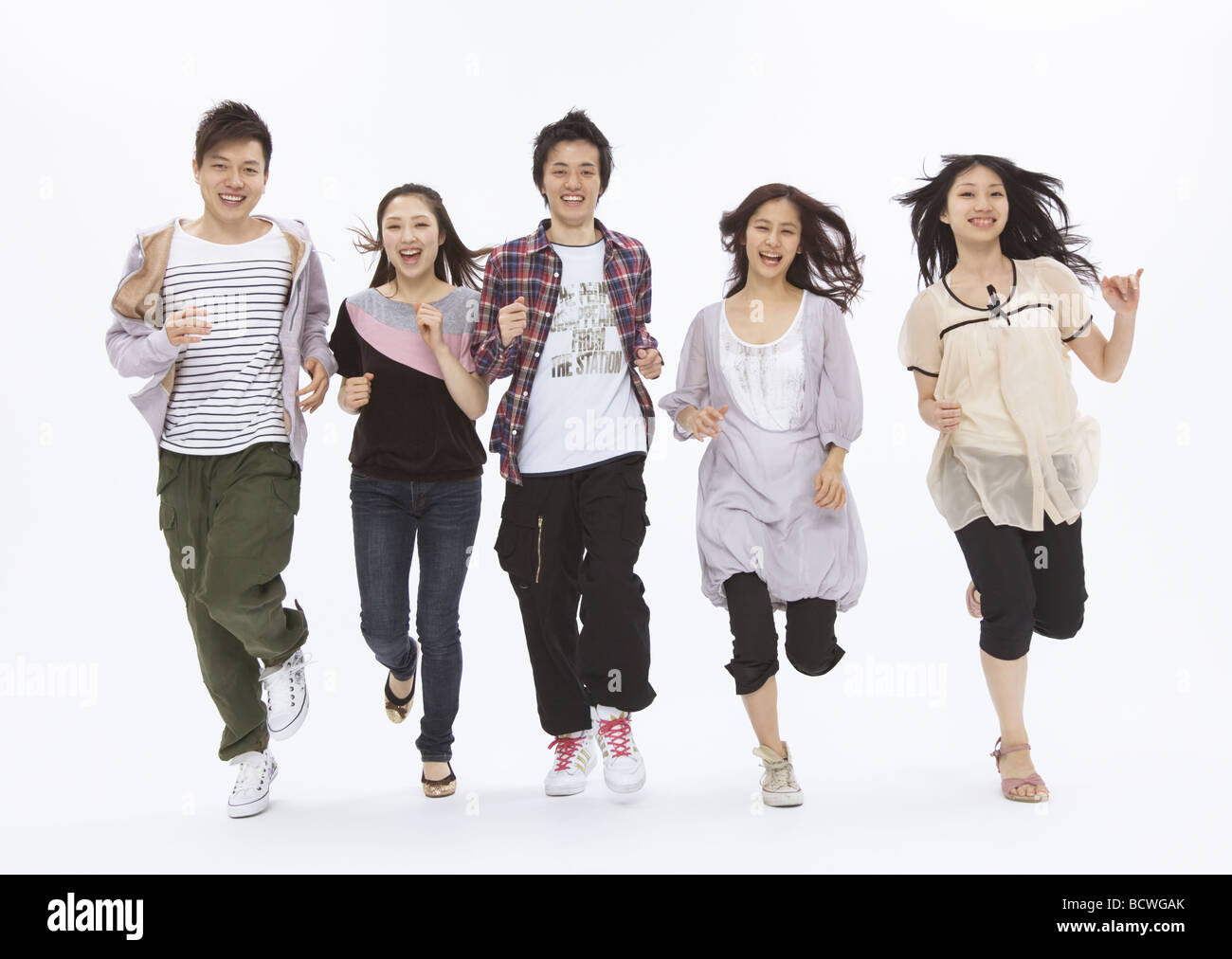 Young men and women running side by side Stock Photo - Alamy