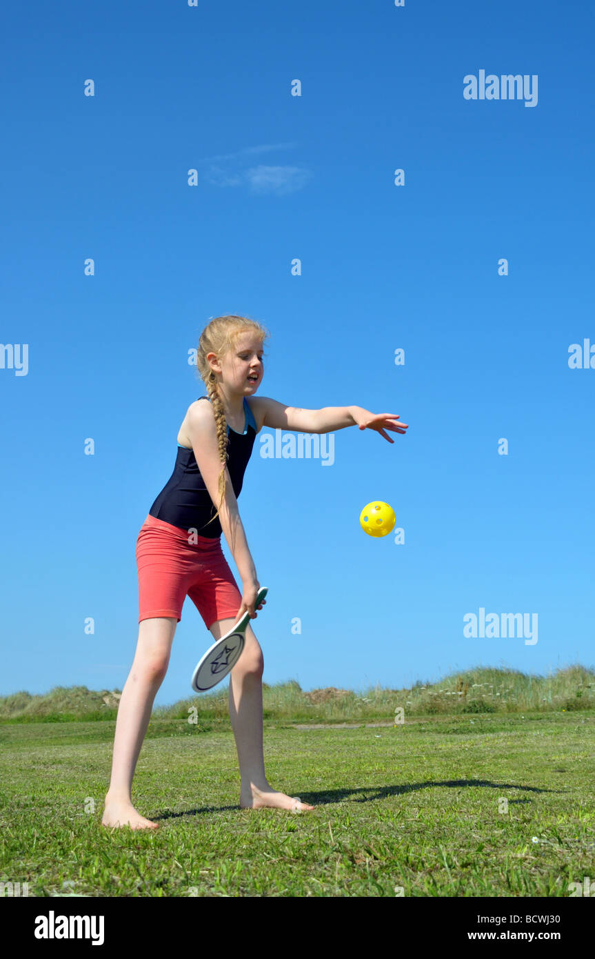 A young girl drops the ball ready to serve it Stock Photo - Alamy