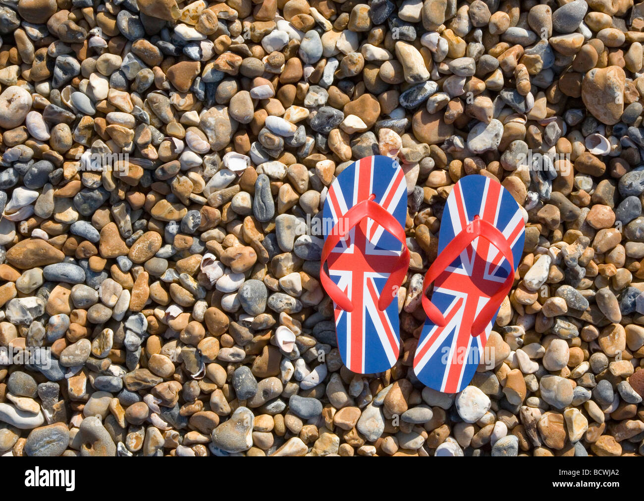 union jack flip-flops on pebble beach Stock Photo - Alamy