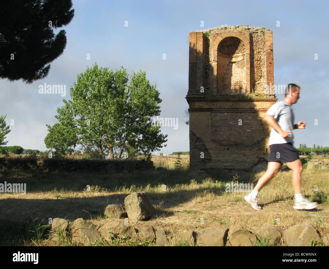 man running on the old appian way in rome italy Stock Photo - Alamy