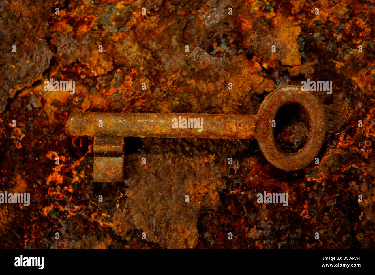Rusty antique key on rusted iron plate Stock Photo - Alamy