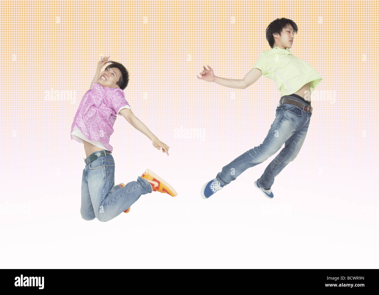 Young men jumping Stock Photo - Alamy