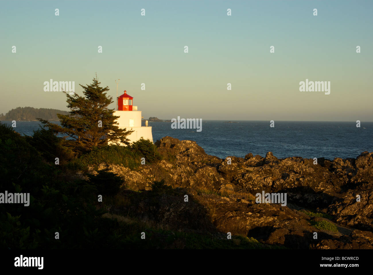 Rugged ocean wind etched west coast shoreline Amphitrite lighthouse on ...