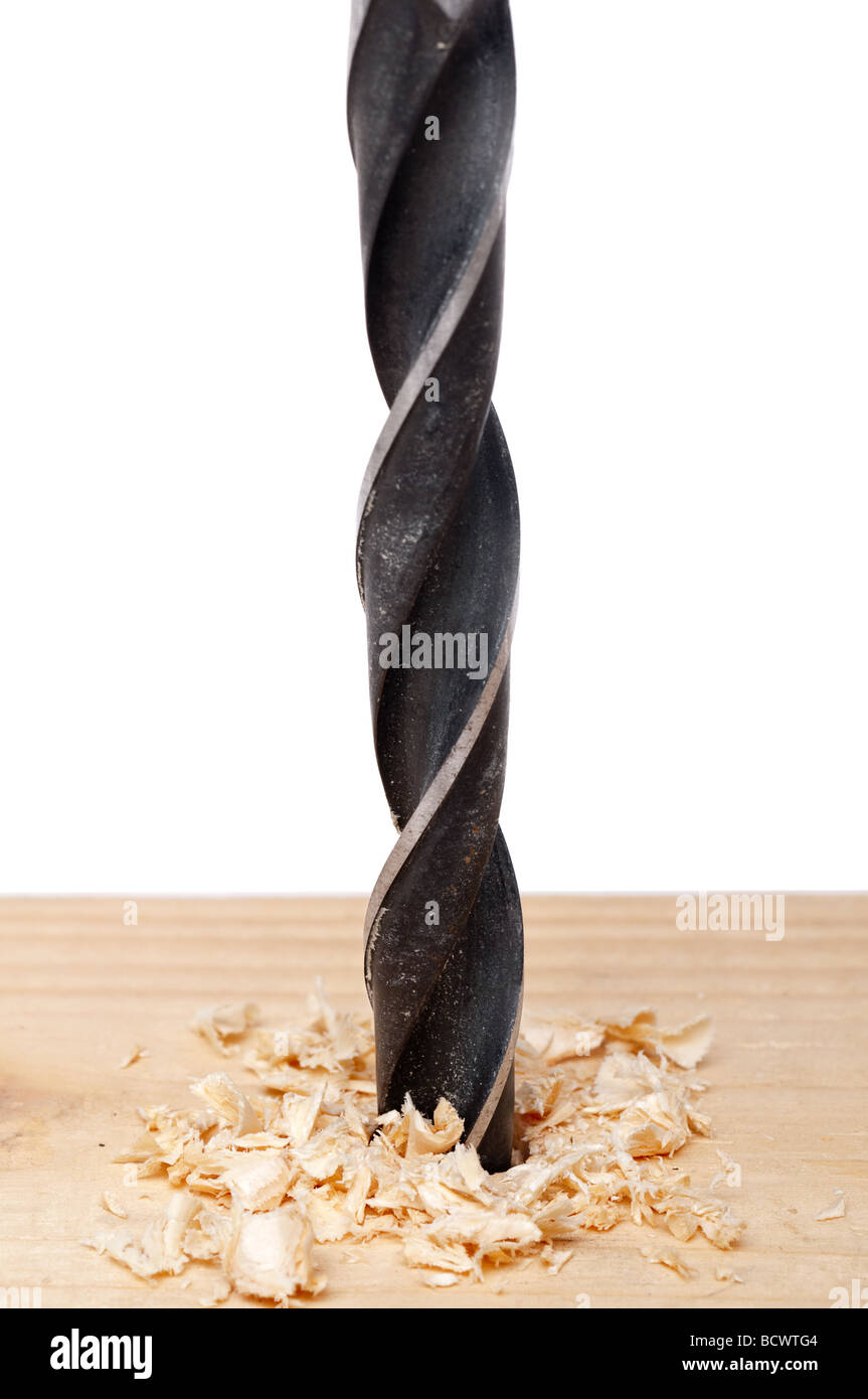 A vertical close up of a hole being bored into wood with a drill bit ...