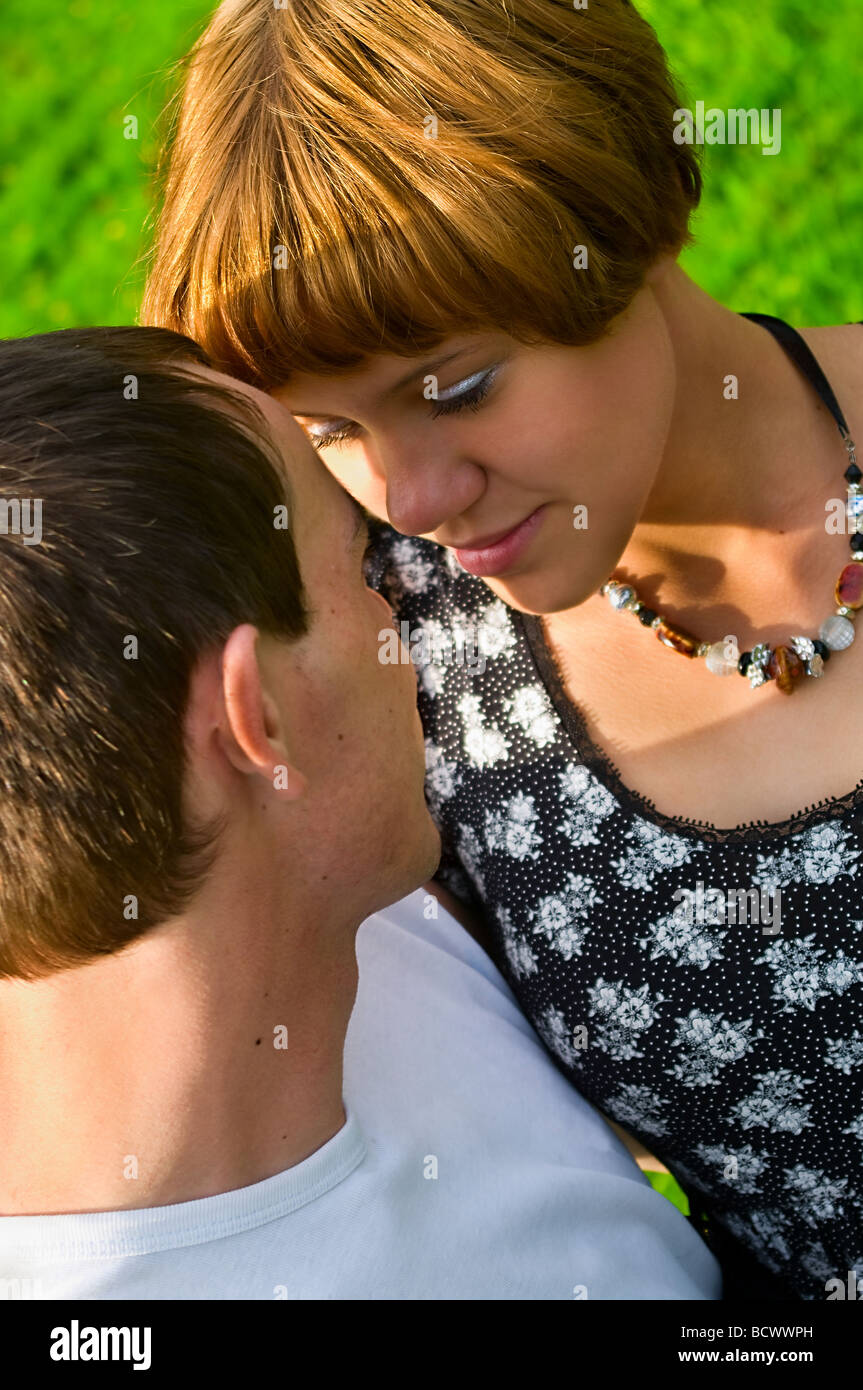 Teenagers: girl and fellow embracing one another. Close up portrait ...