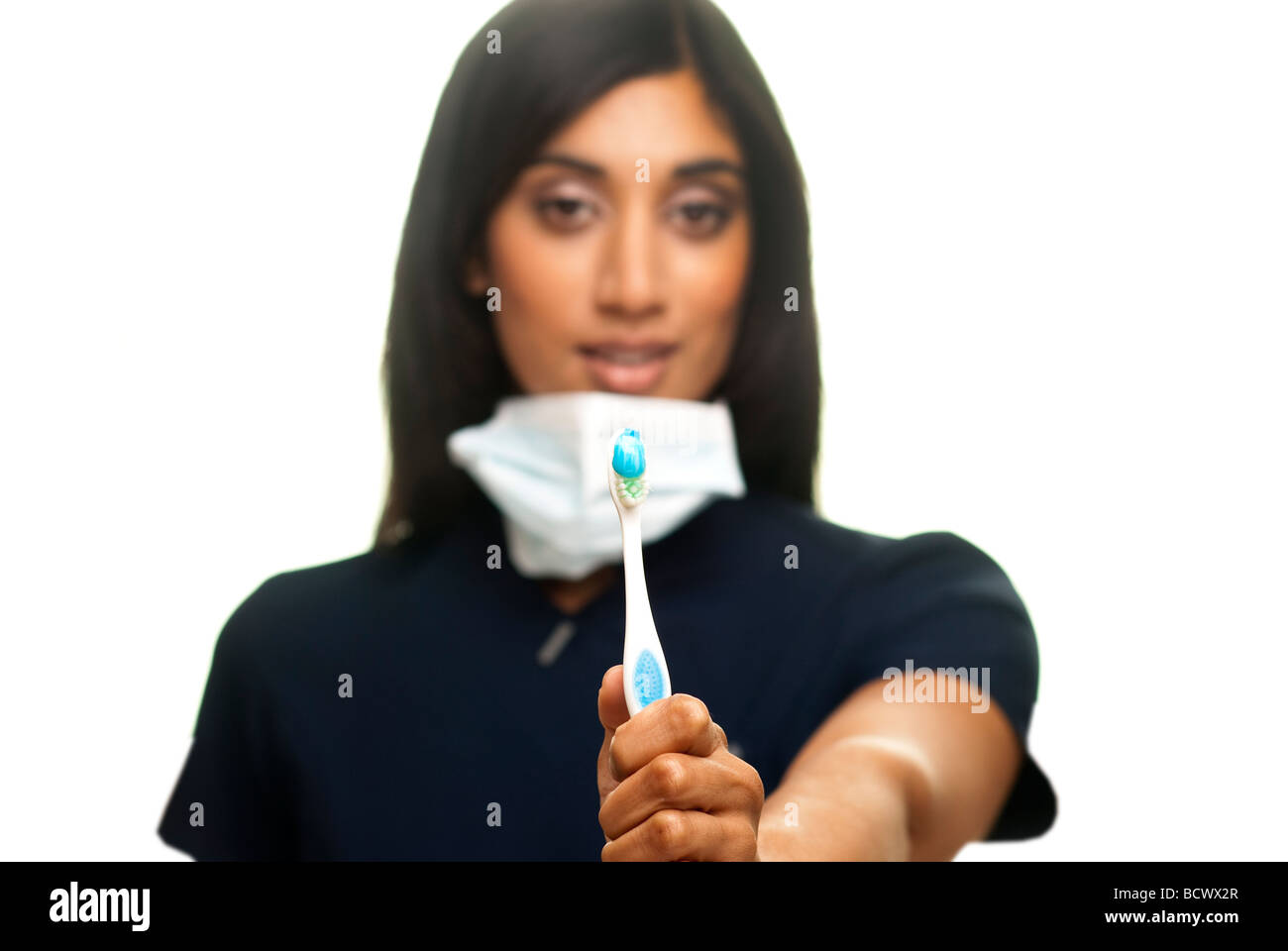 dentist holding a toothbrush with toothpaste Stock Photo - Alamy