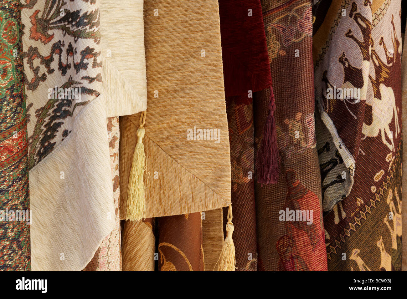Richly coloured traditional fabric for sale at the market in a bazaar ...