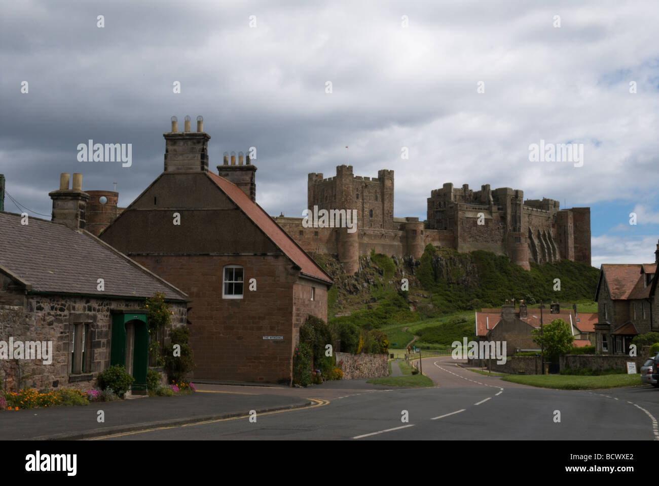 Bamburgh Castle seen through houses in village of Bamburgh ...