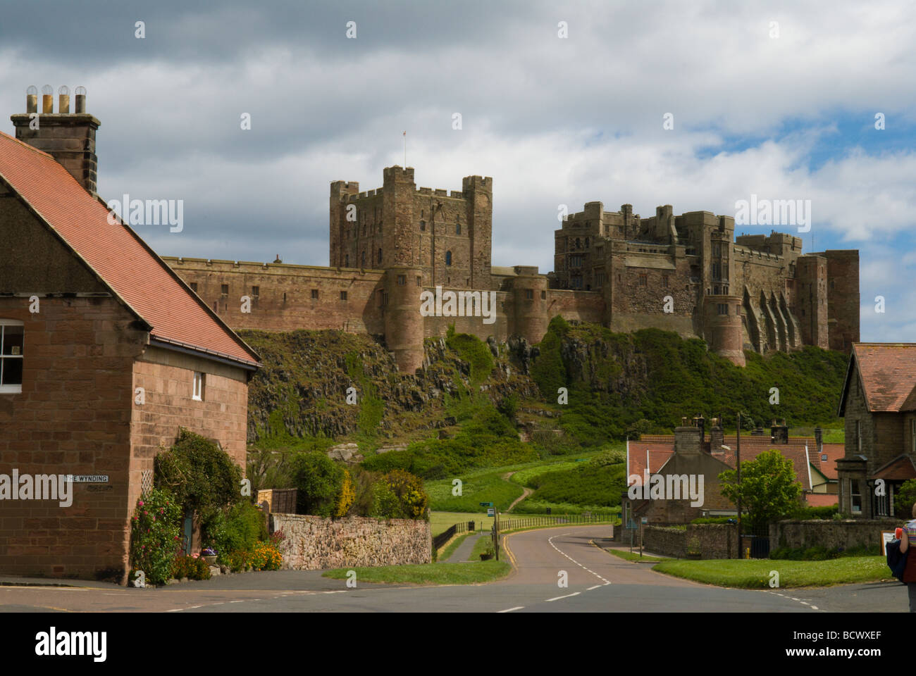 Bamburgh Castle seen through houses in village of Bamburgh ...