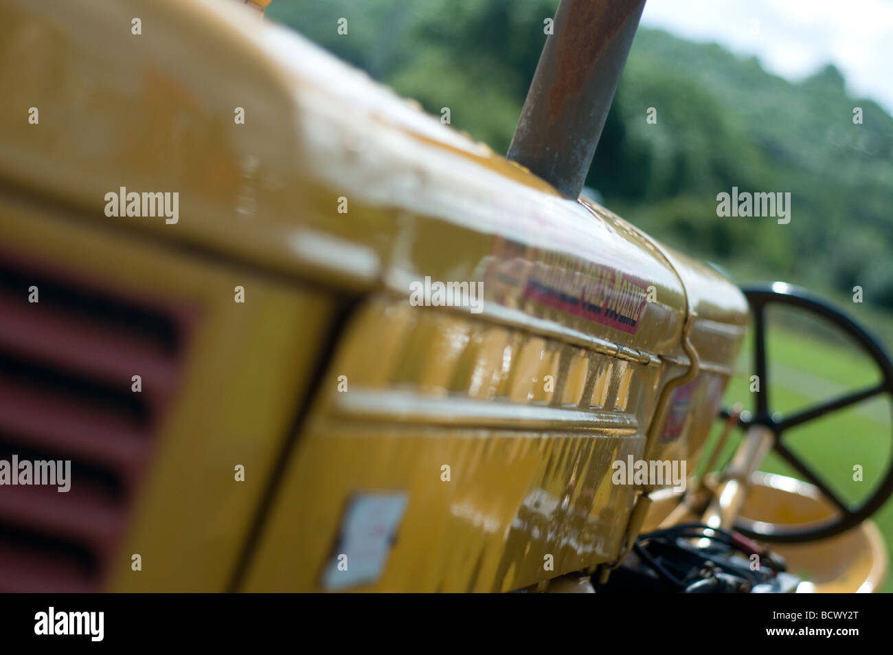 Yellow Vintage Tractor parked in a field Stock Photo - Alamy