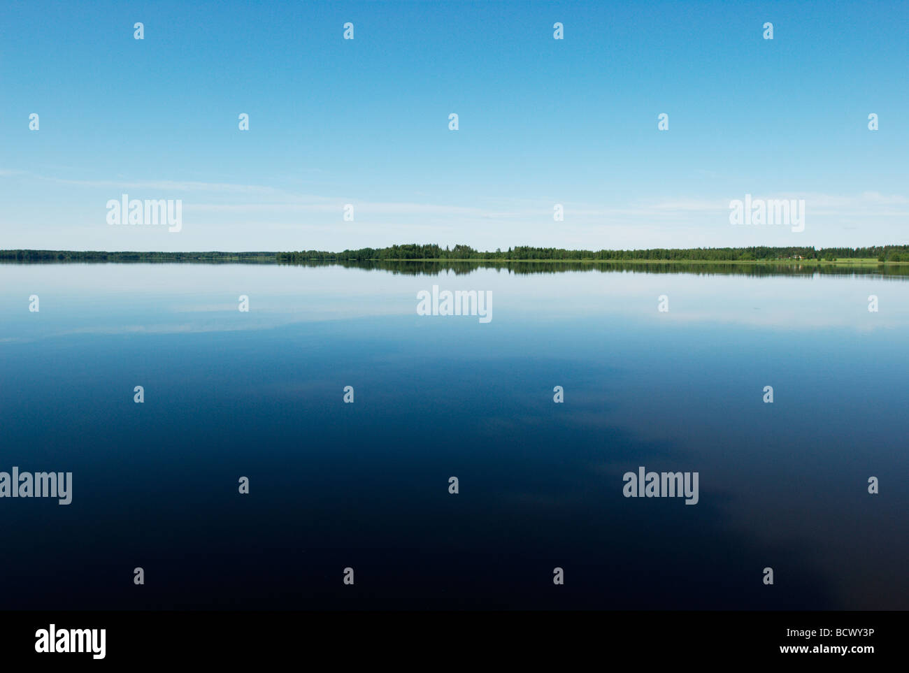 Calm lake and blue sky Stock Photo - Alamy