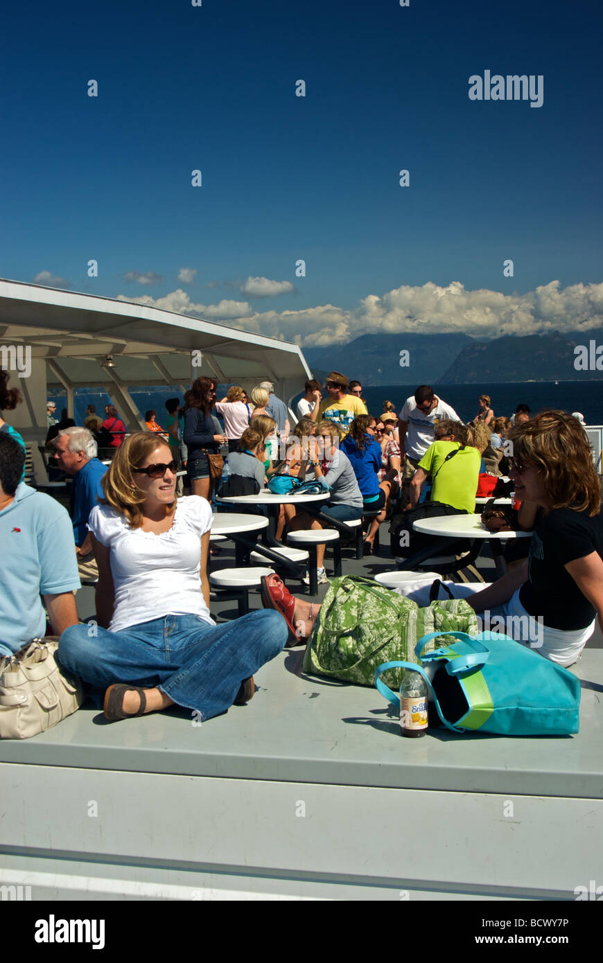 Passengers enjoying spectacular mountain sea sunshine from crowded ...