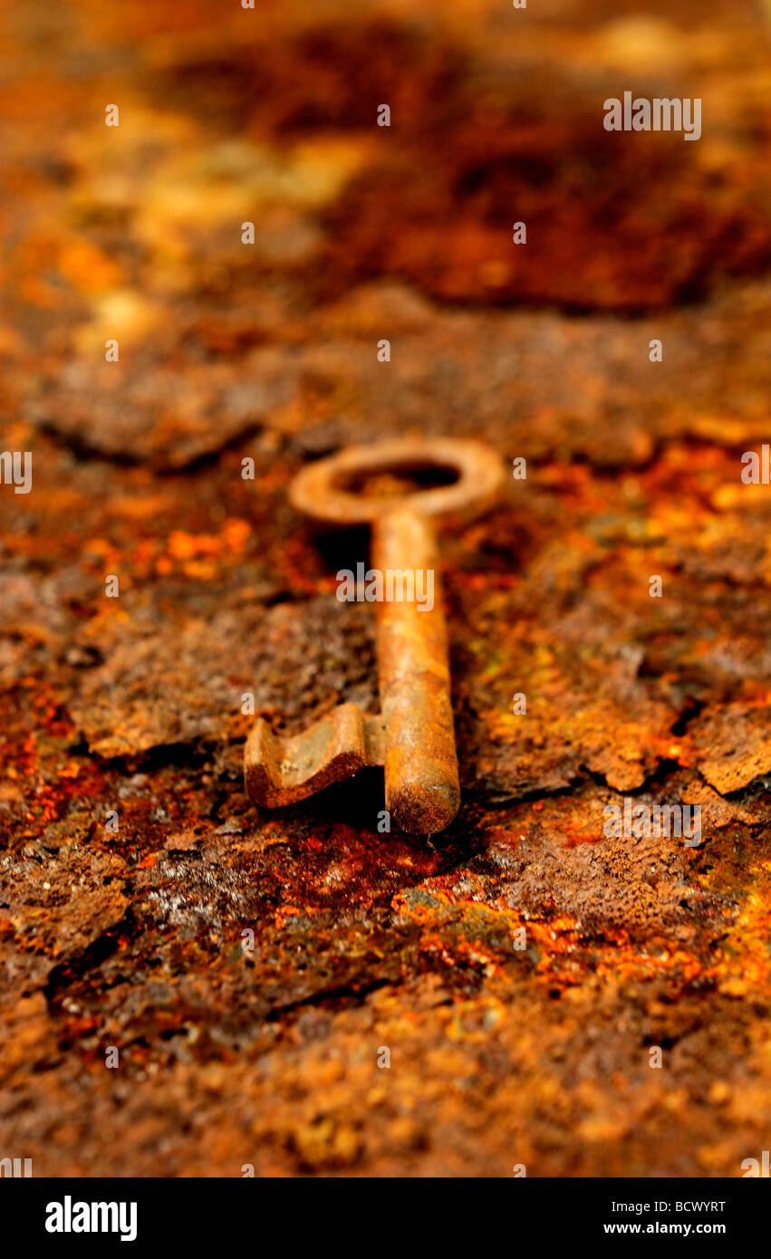 Rusty antique key on rusted iron plate Stock Photo - Alamy