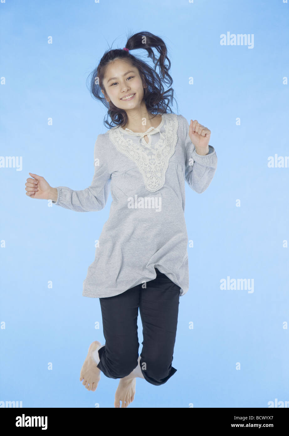 Young woman jumping Stock Photo - Alamy