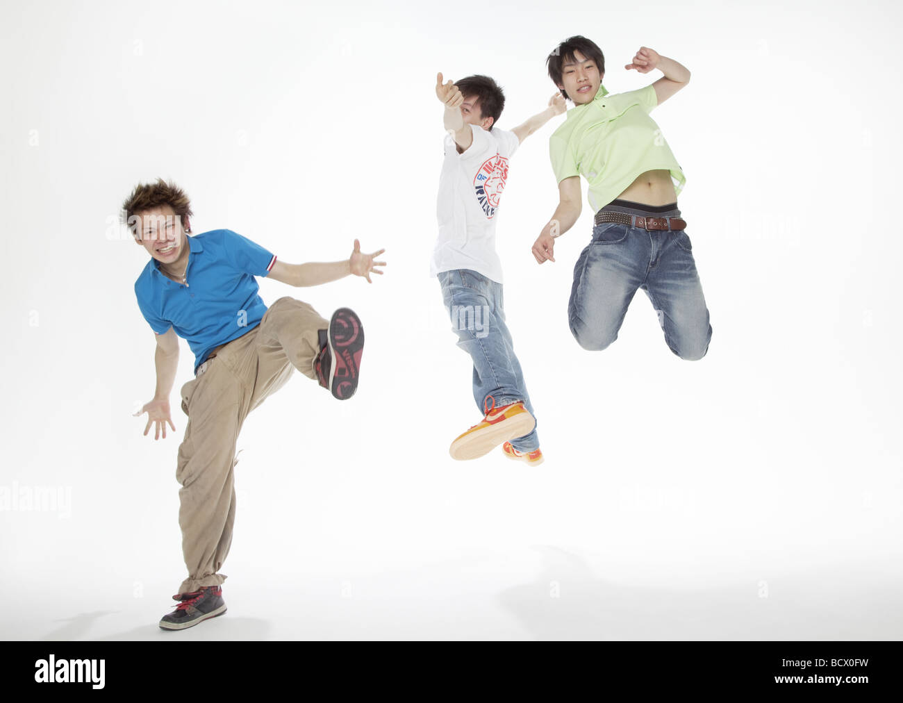 Young men jumping Stock Photo - Alamy