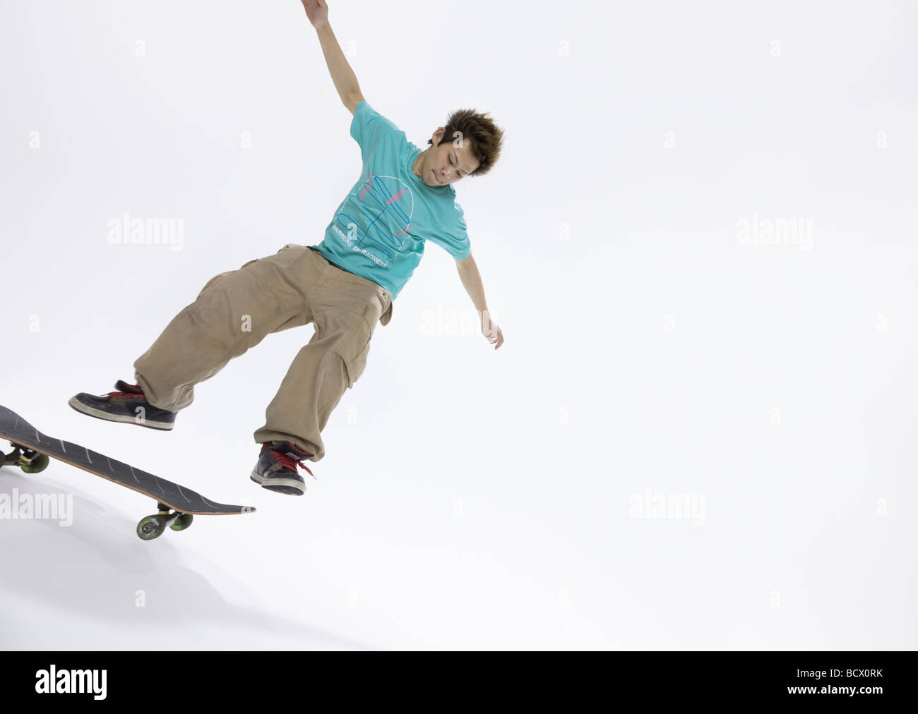 Young man skateboarding Stock Photo - Alamy